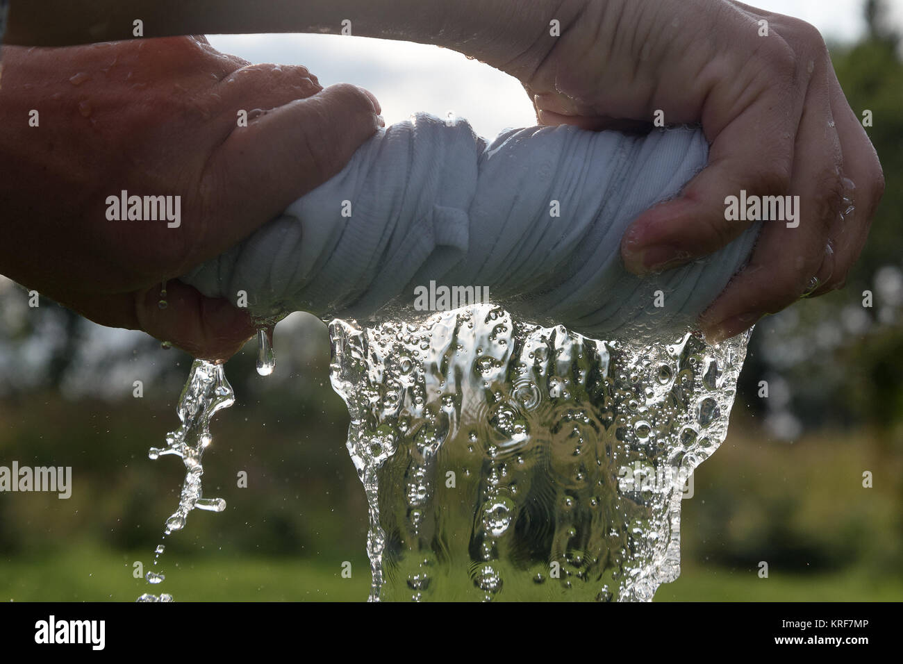 Hands squeeze wet cloth Stock Photo - Alamy
