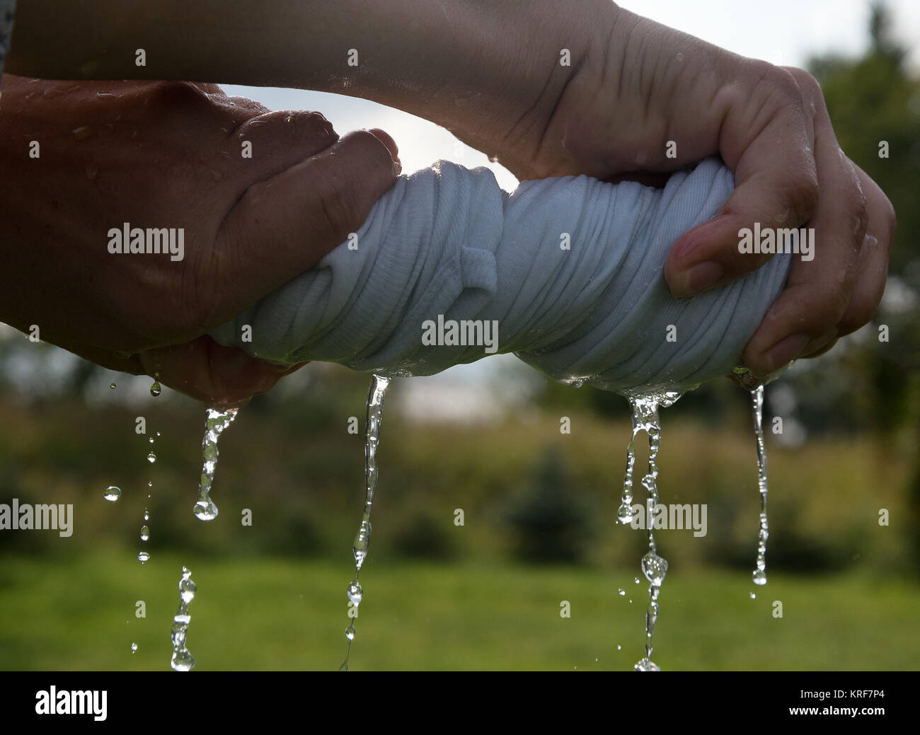 Hands squeeze wet cloth Stock Photo - Alamy