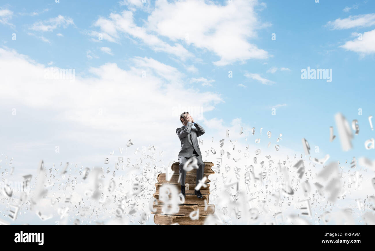 Young man floating in sky and do not want to see anything Stock Photo ...