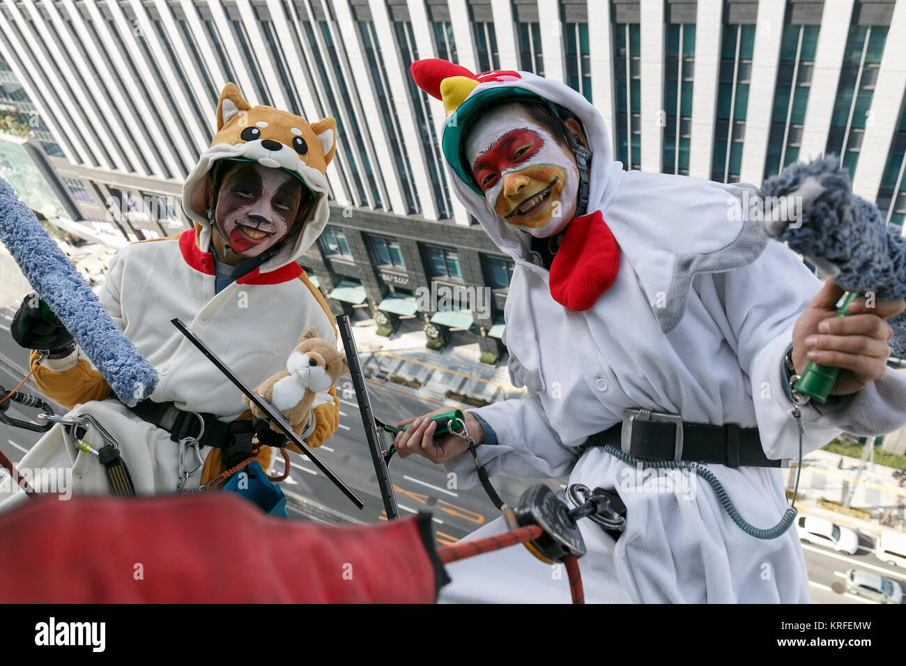 Tokyo, Japan. 20th December, 2017. Window cleaners dressed as dog and ...