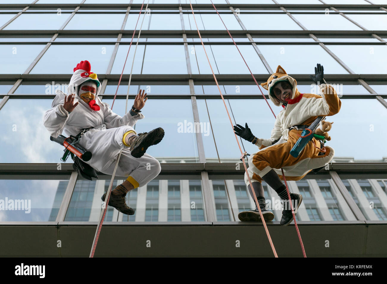 Tokyo, Japan. 20th December, 2017. Window cleaners dressed as dog and ...