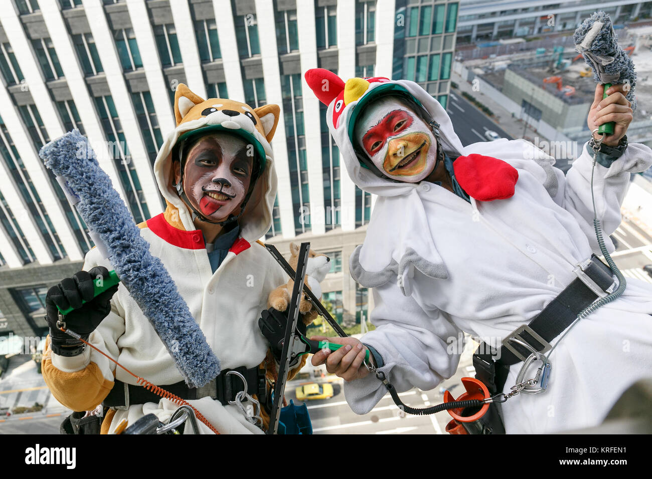 Tokyo, Japan. 20th December, 2017. Window cleaners dressed as dog and ...