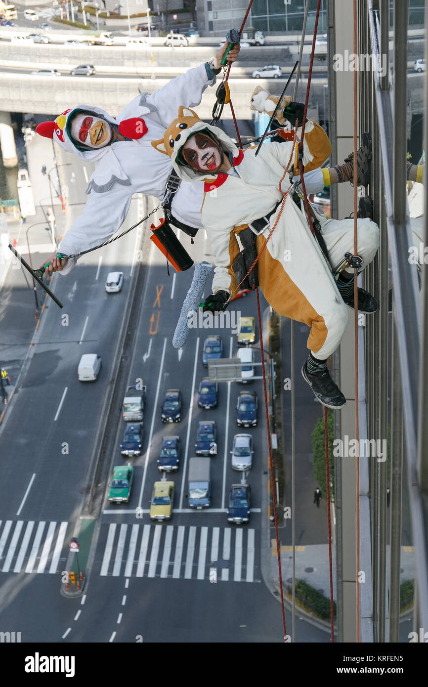 Tokyo, Japan. 20th December, 2017. Window cleaners dressed as dog and ...