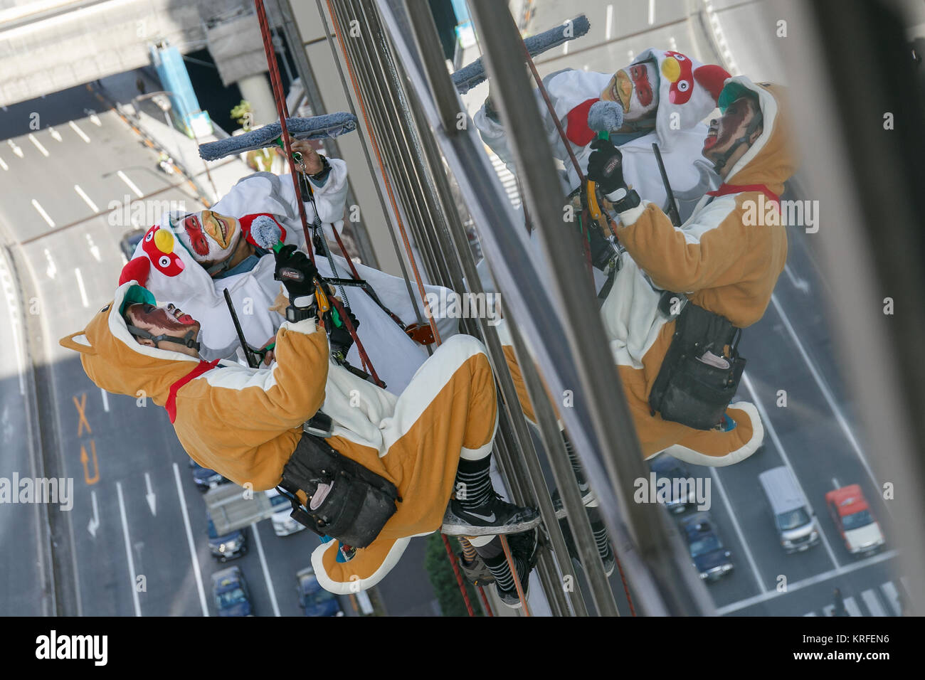 Tokyo, Japan. 20th December, 2017. Window cleaners dressed as dog and ...
