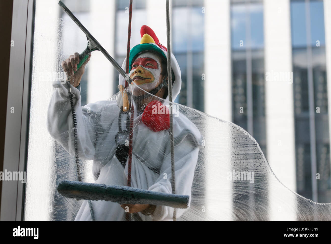 Tokyo, Japan. 20th December, 2017. A window cleaner dressed as rooster ...