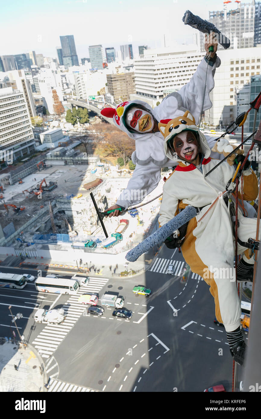Tokyo, Japan. 20th December, 2017. Window cleaners dressed as dog and ...