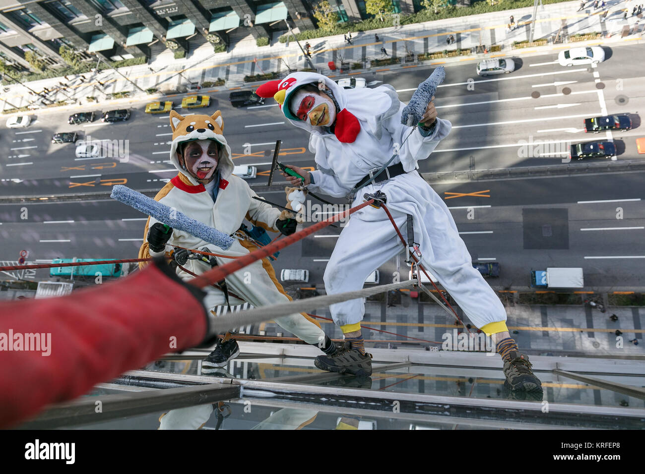 Tokyo, Japan. 20th December, 2017. Window cleaners dressed as dog and ...