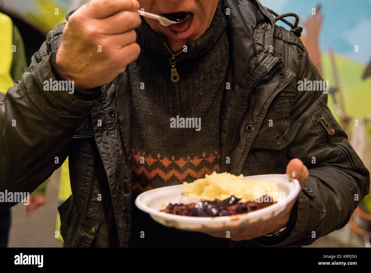 Munich, Germany. 16th Nov, 2017. A homeless man eats food handed out by ...