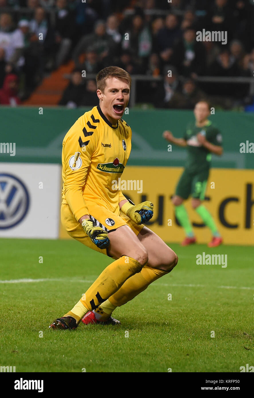 Freiburg's goalkeeper Alexander Schwolow celebrates after parrying a ...