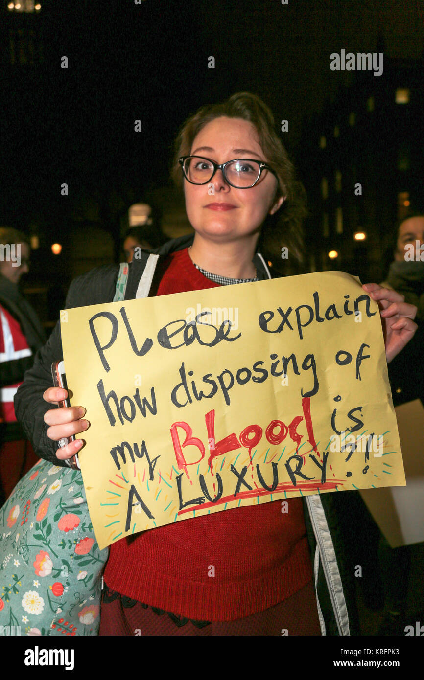 London, UK. 20th Dec, 2017. A person holds a handwritten protest sign ...