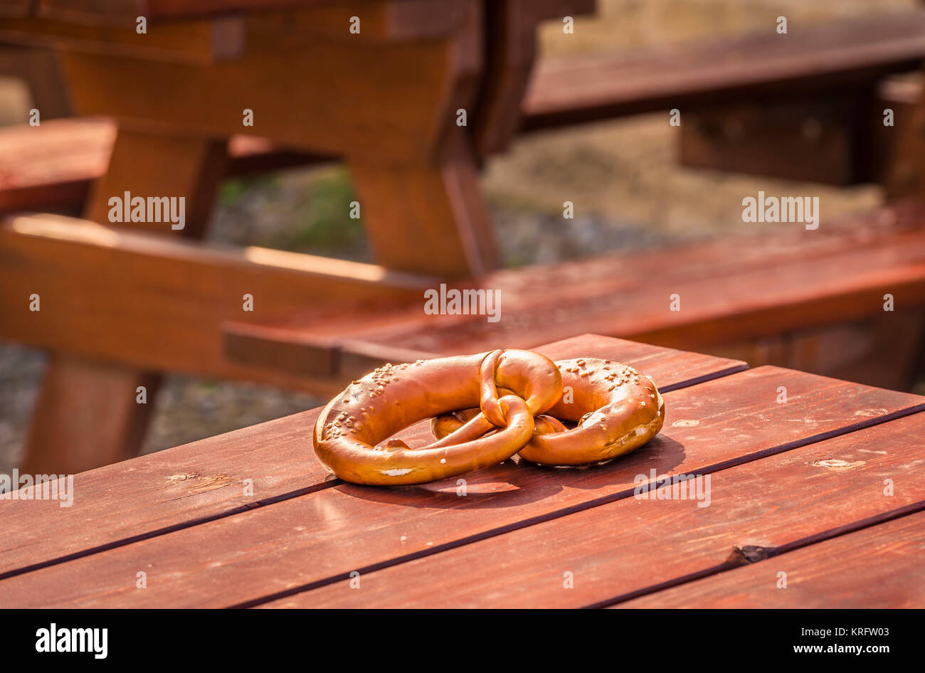 German pretzel on wooden table Stock Photo - Alamy