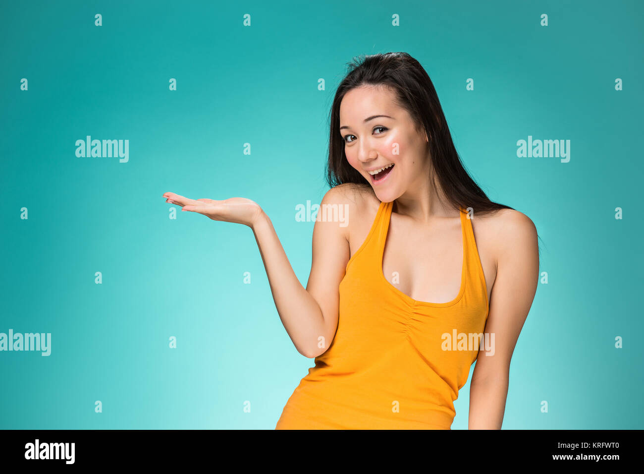 The happy Chinese girl on yellow background Stock Photo - Alamy