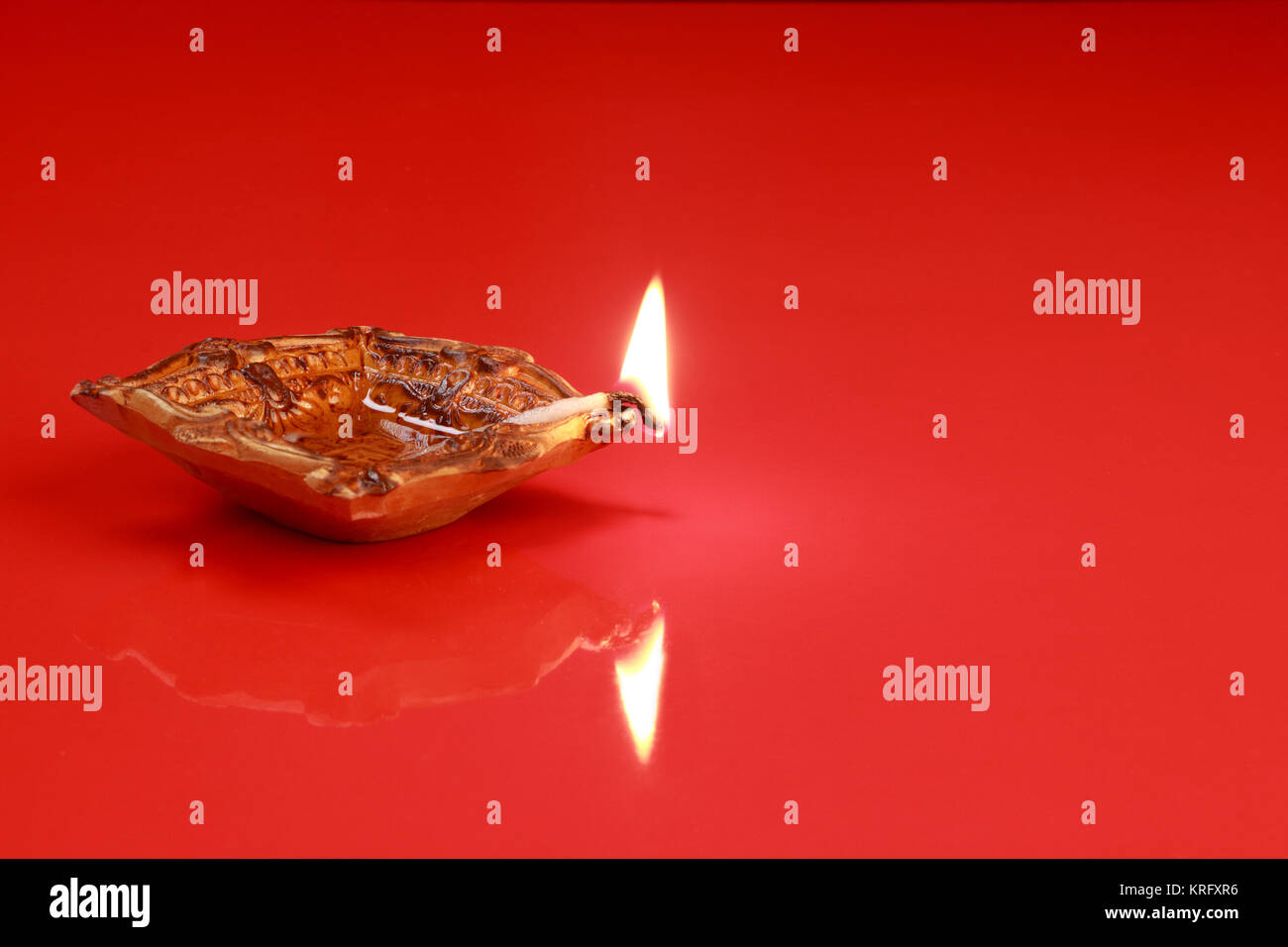 Handmade Diwali Clay Lamp on Red Color Background Stock Photo - Alamy