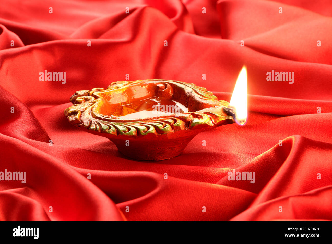Handmade Diwali Clay Lamp on Red Satin Background Stock Photo - Alamy