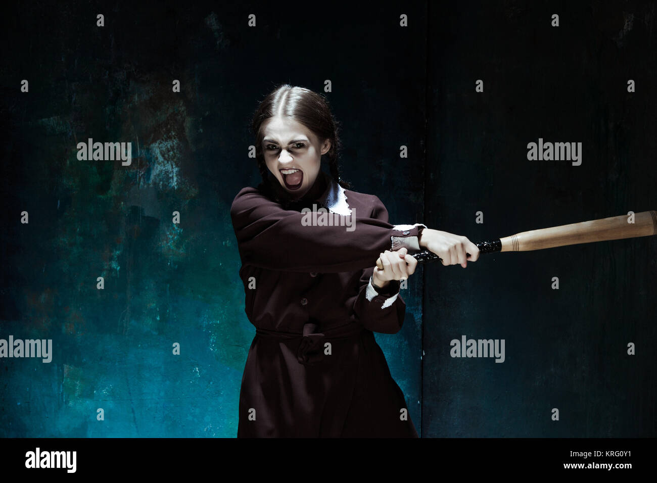 Portrait of a young girl in school uniform as killer woman Stock Photo ...