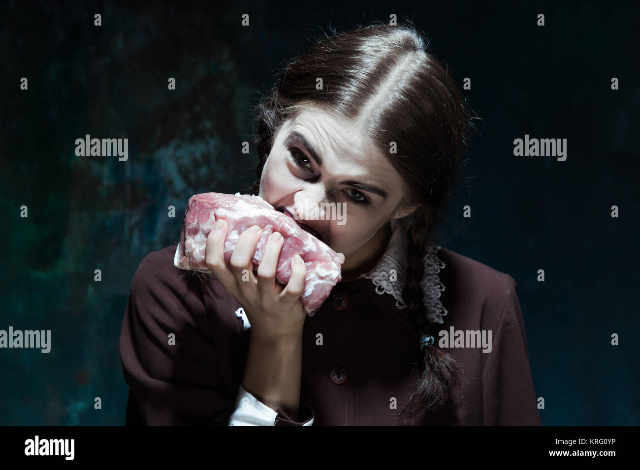 Bloody Halloween theme: crazy girl with raw meat Stock Photo - Alamy