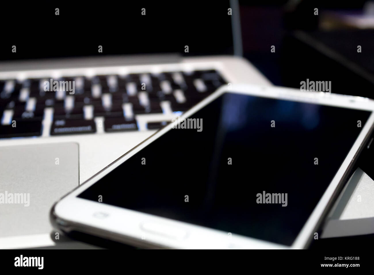 Phone on the laptop Stock Photo - Alamy