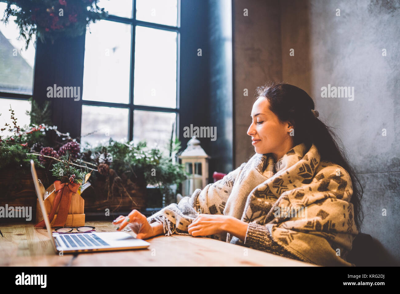 beautiful young girl uses laptop technology, types text looking at the ...