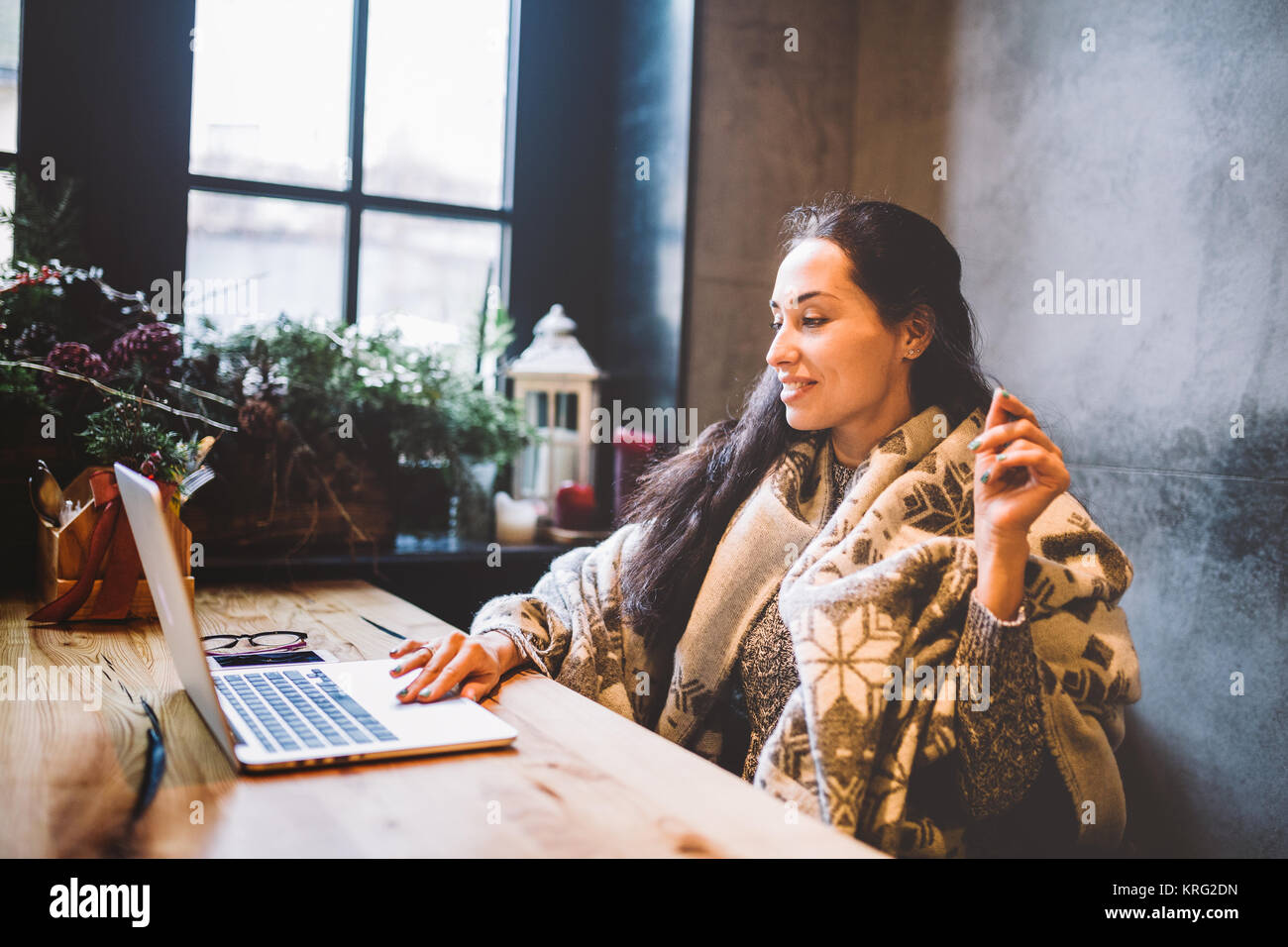 beautiful young girl uses laptop technology, types text looking at the ...