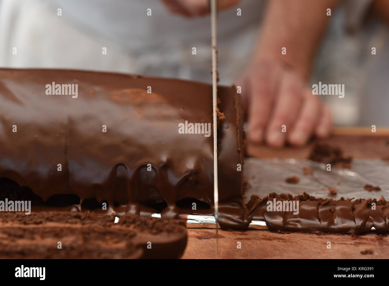 Chocolate roll being sliced with a knife Stock Photo - Alamy