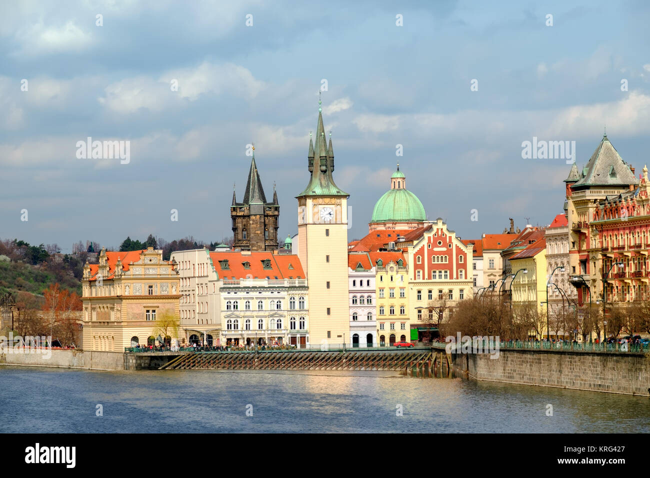 Historical buildings in Prague from across the river under dramatic sky ...