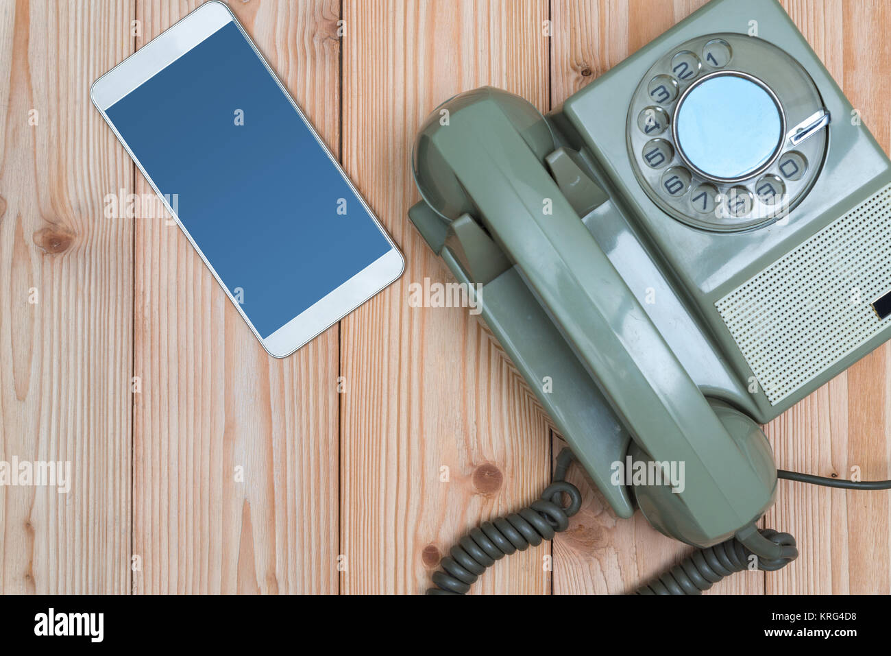 Retro rotary telephone or vintage phone with cable and new cell phone ...