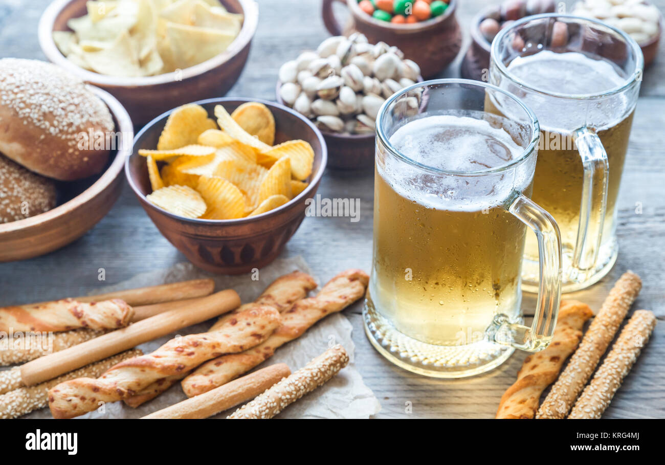 Two glasses of beer with appetizers Stock Photo - Alamy