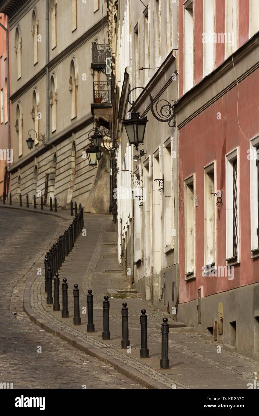 paved with stones climbing the arch uphill street in Warsaw Mariensztat ...