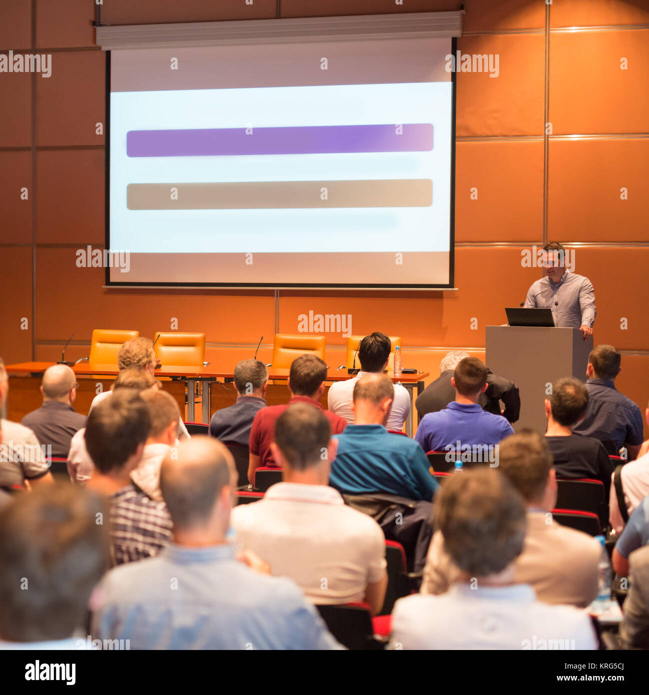 Business speaker giving a talk in conference hall Stock Photo - Alamy