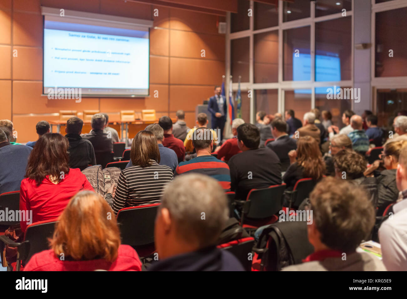 Business speaker giving a talk in conference hall Stock Photo - Alamy