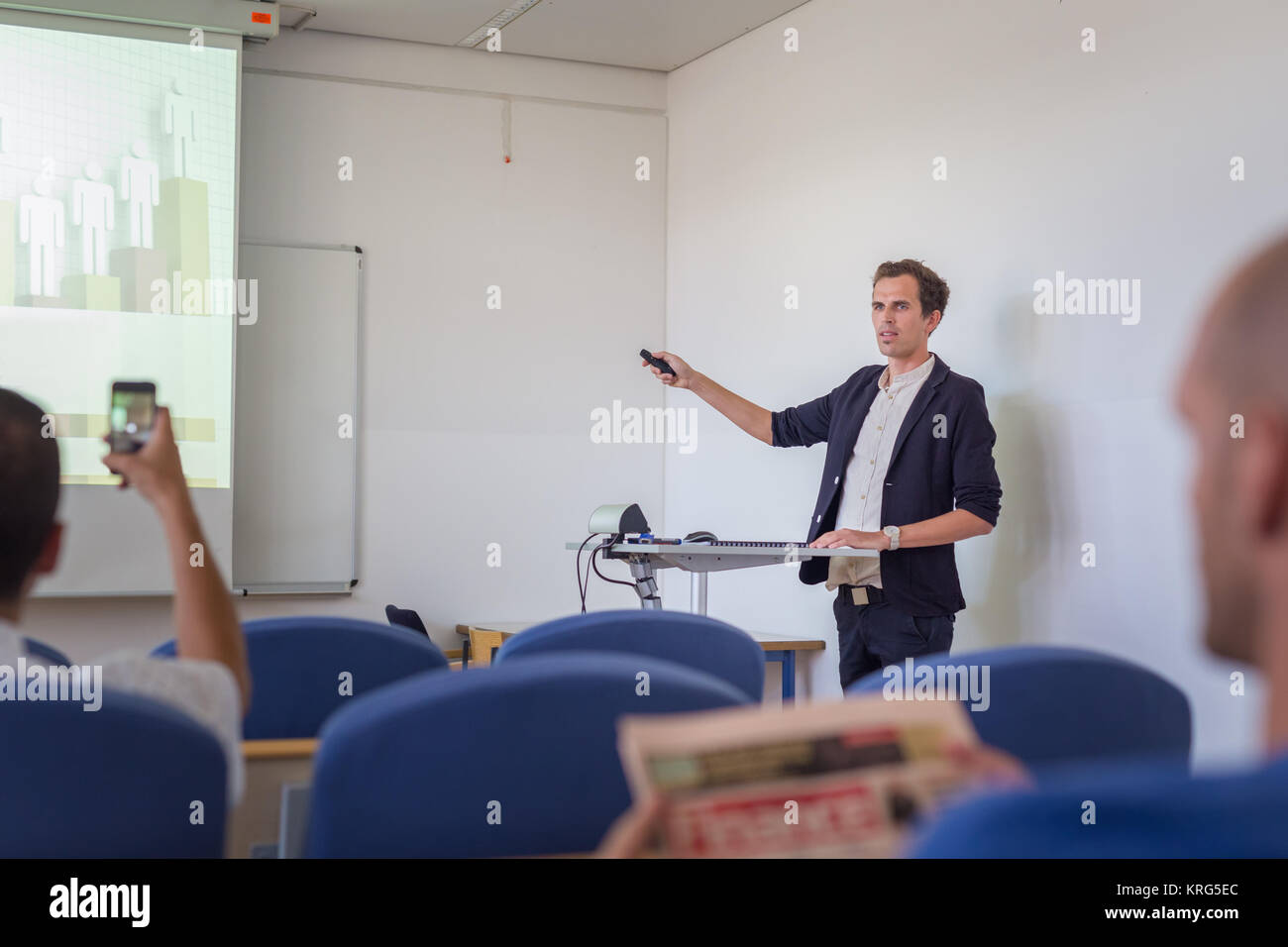 Student presenting his study work in front of whiteboard Stock Photo ...