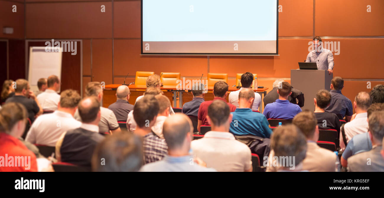 Business speaker giving a talk in conference hall Stock Photo - Alamy