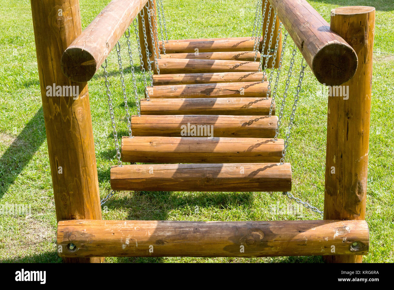 childrens bridge made of logs and chains Stock Photo - Alamy