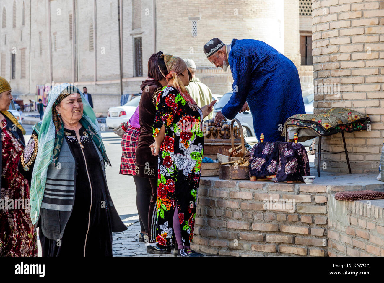 An Elderly Uzbek Man Sells Souvenirs From A Stall In The Market ...