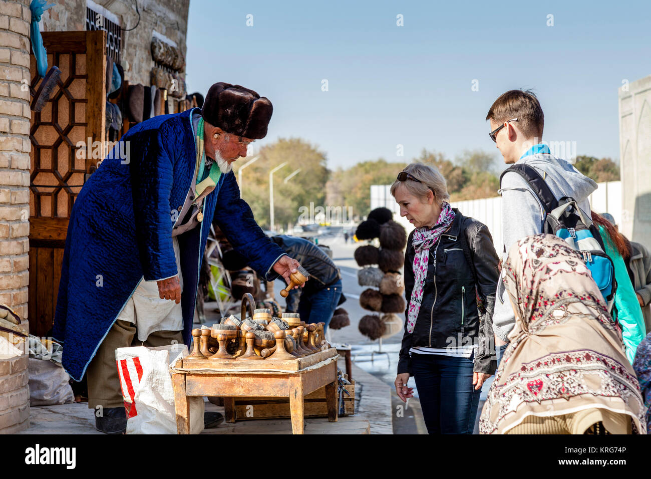 An Elderly Uzbek Man Sells Souvenirs From A Stall In The Market ...