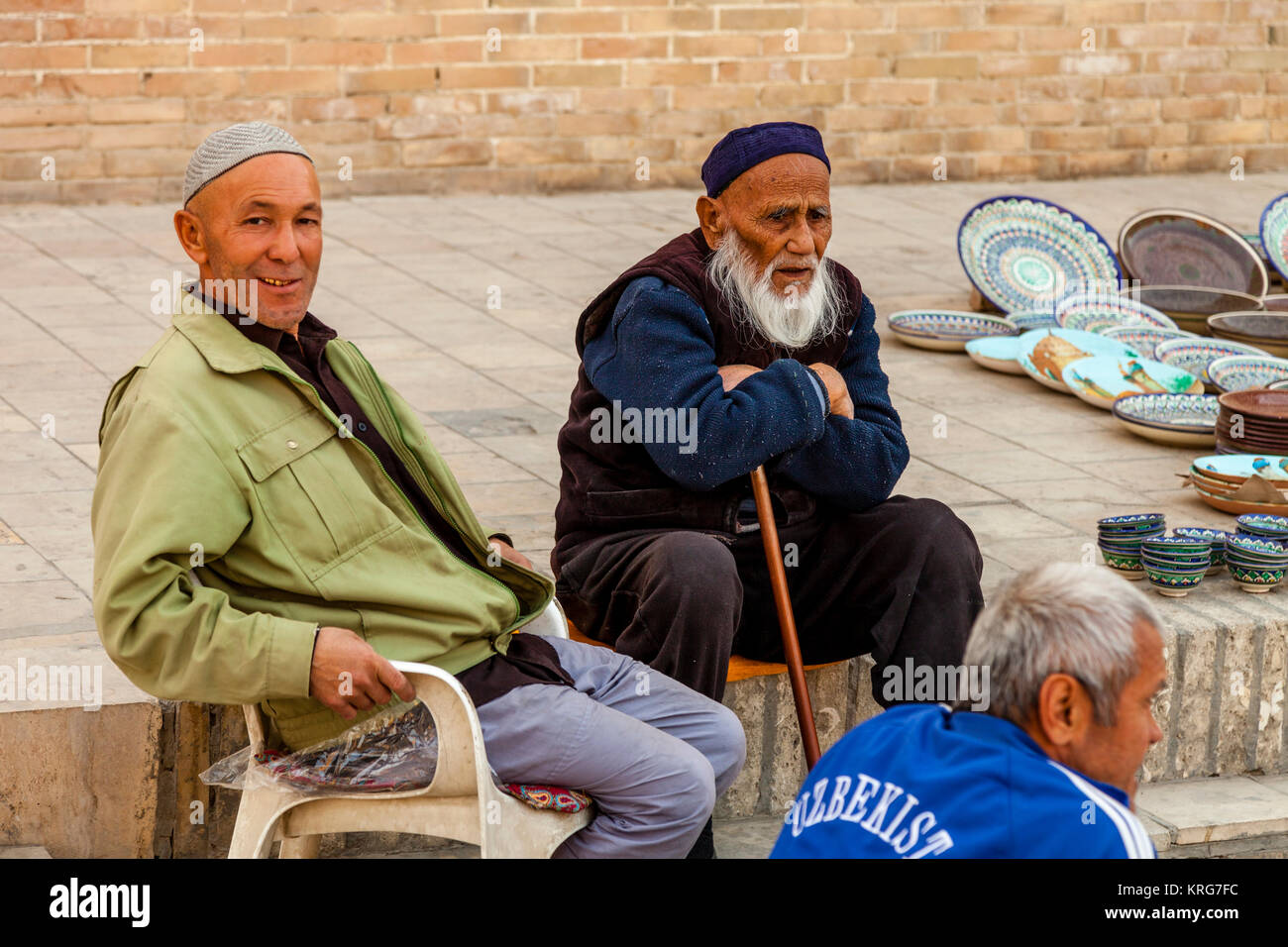 Uzbek Men Sitting In The Street, Bukhara, Uzbekistan Stock Photo - Alamy