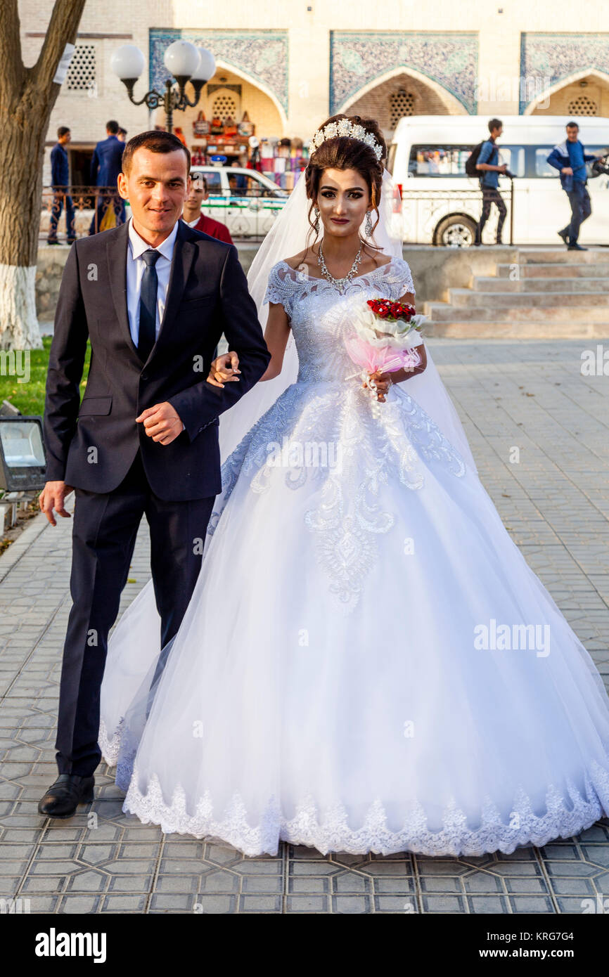 A Young Uzbek Couple Walk Through The Streets Of Bukhara After Just ...