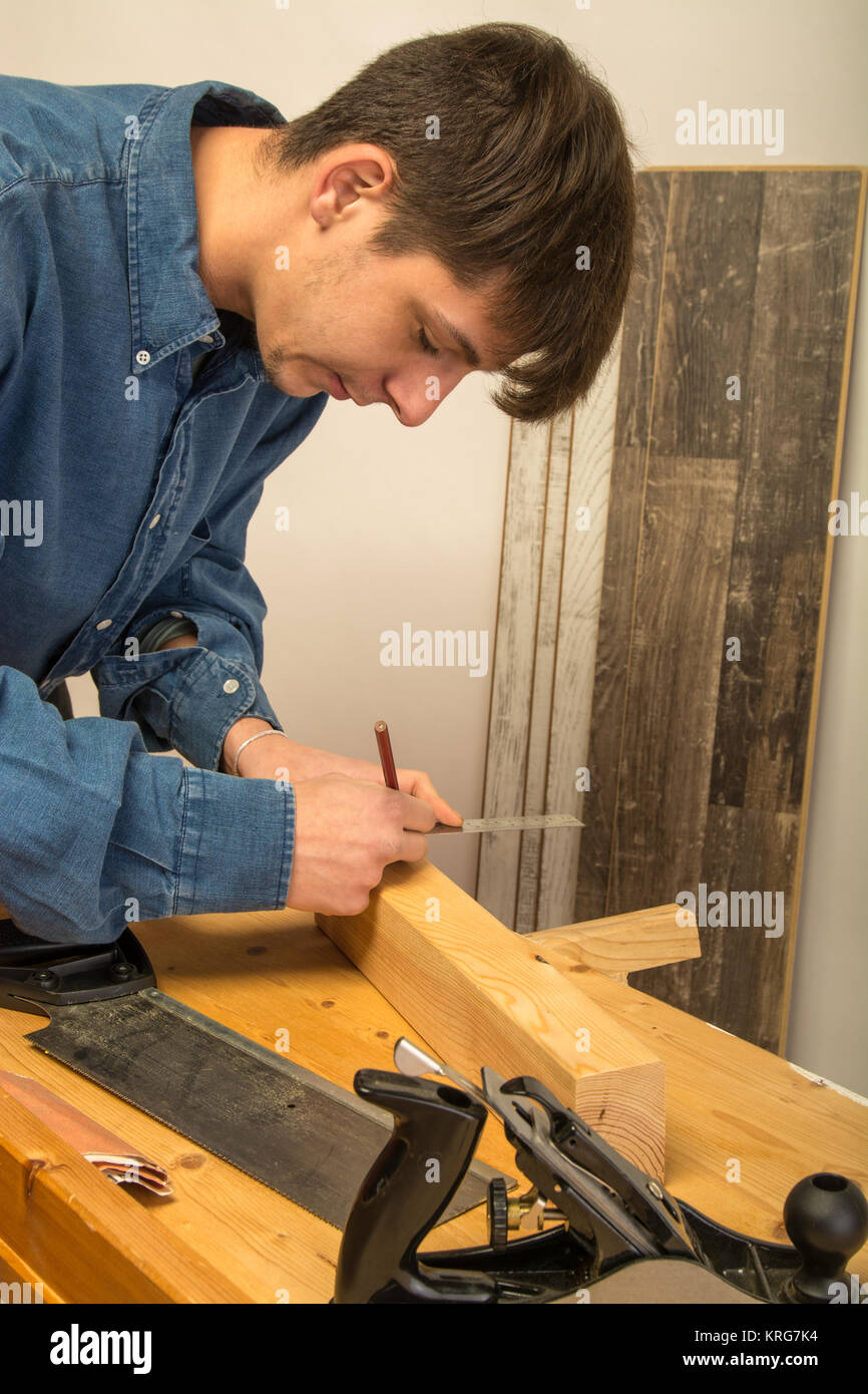 worker man working on wood taking measures Stock Photo - Alamy