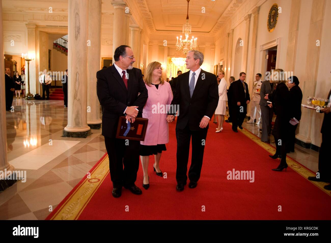 U.S. President George W. Bush walks with George Monsoor and Sally ...