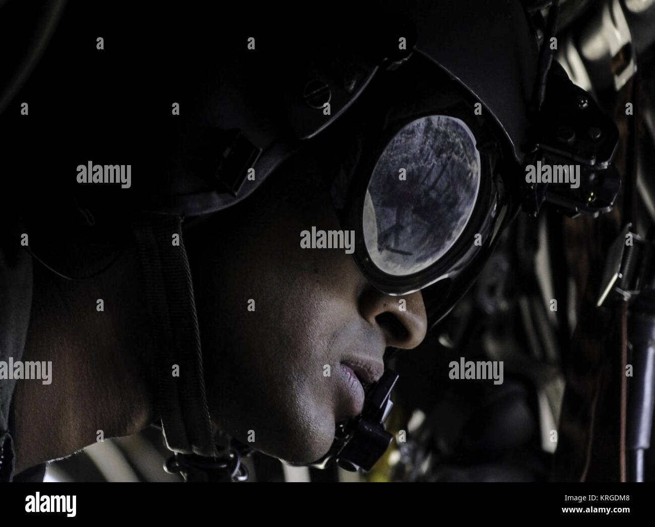 A Singapore air force crew chief looks out the window of a CH-47 ...