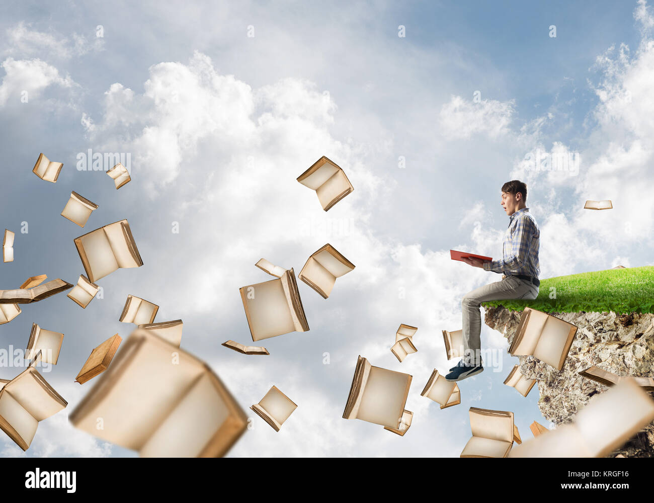 Man reading book and many of them flying in air Stock Photo - Alamy