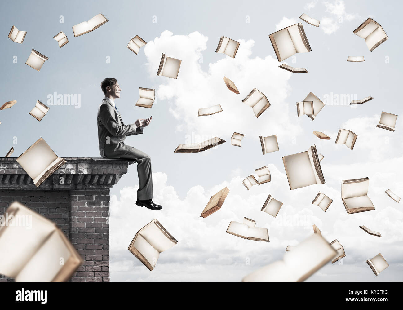 Man using smartphone and many books flying in air Stock Photo - Alamy