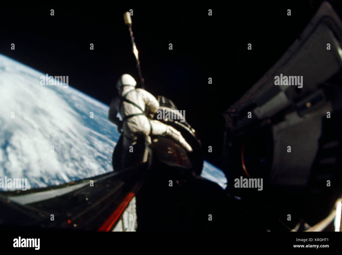 Astronaut Richard Gordon attaches a tether line from his spacecraft to ...