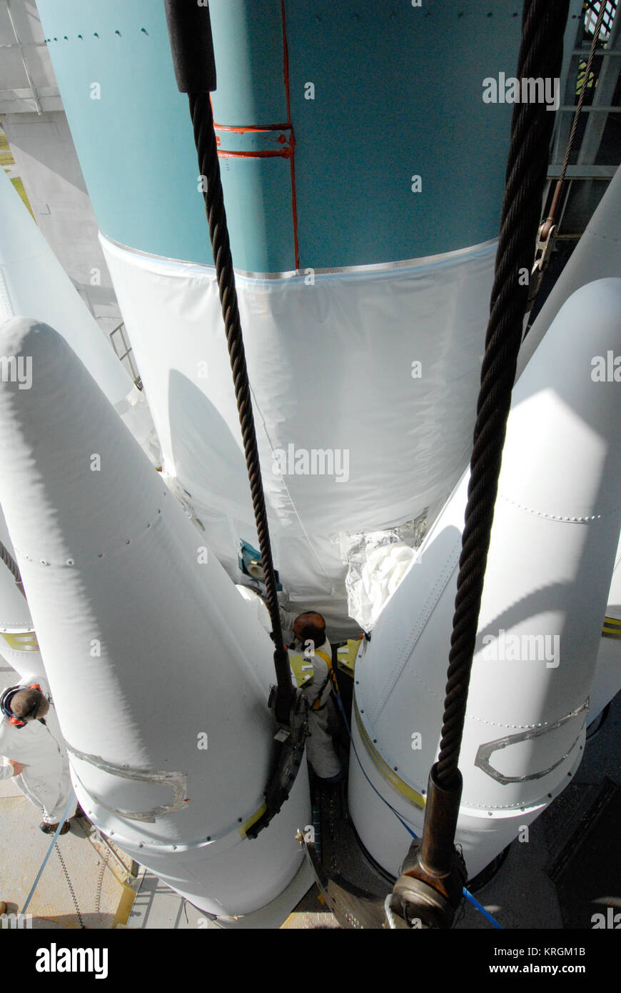 Technicians between heavy booster and Delta II first stage Stock Photo ...