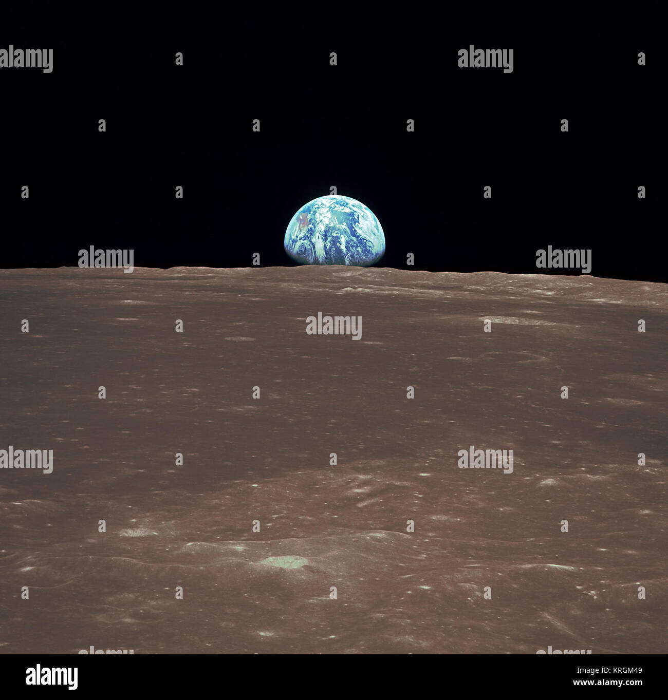 View from the Apollo 11 shows Earth rising above the moon's horizon ...