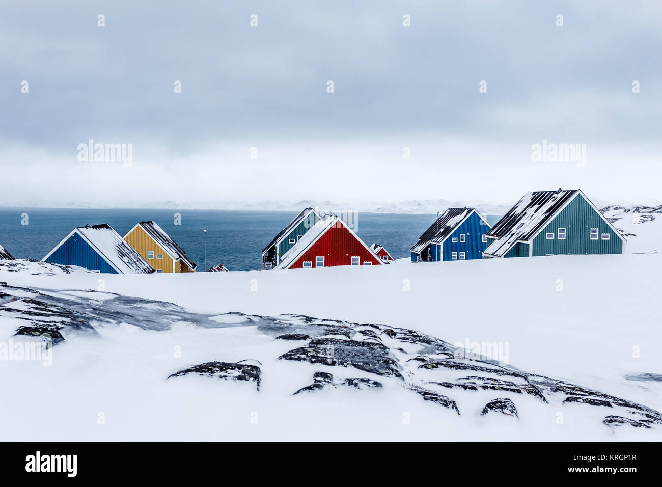 Rows of colorful inuit houses among rocks in a suburb of arctic capital ...