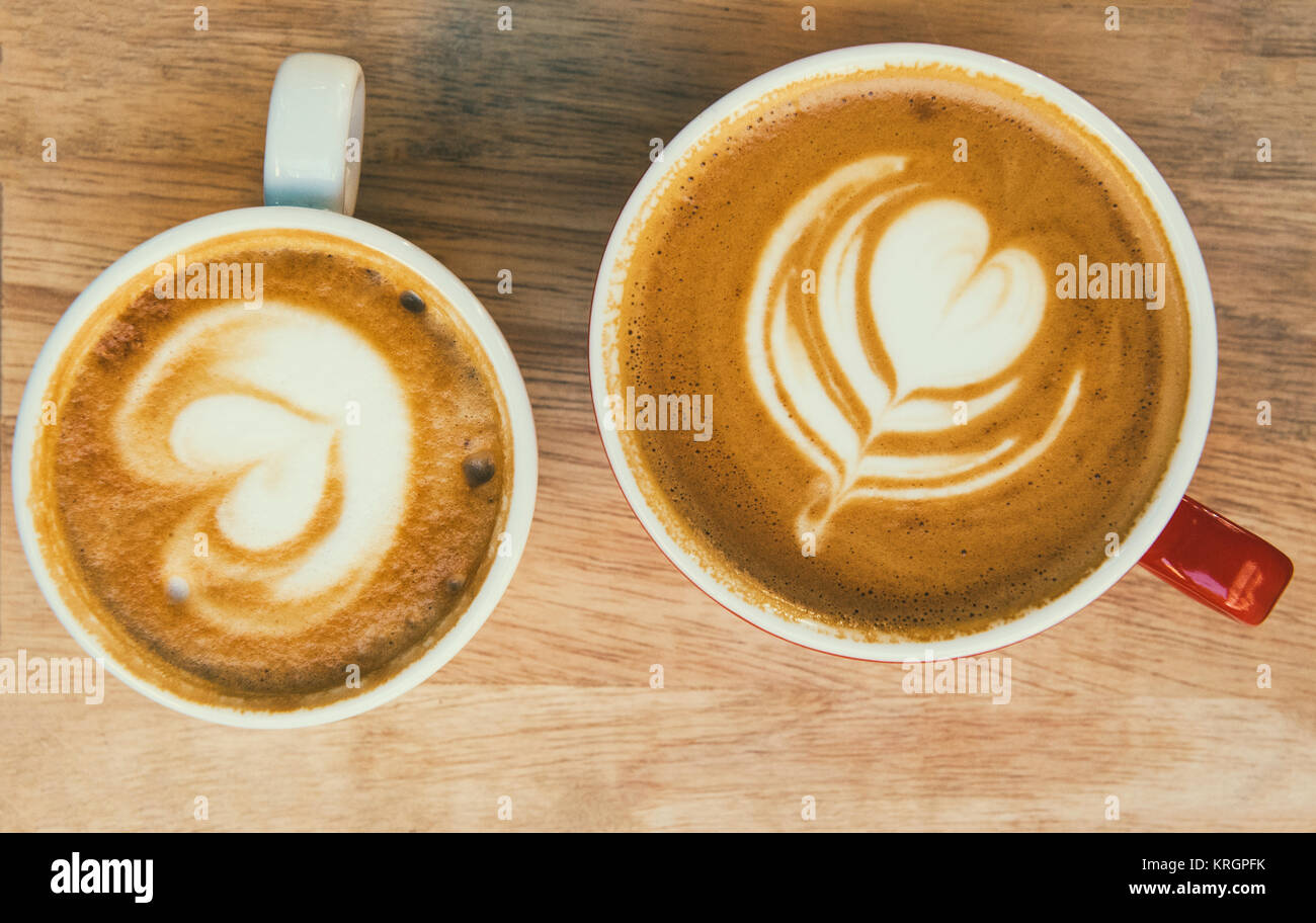 Two cups of coffee with beautiful latte art Stock Photo - Alamy