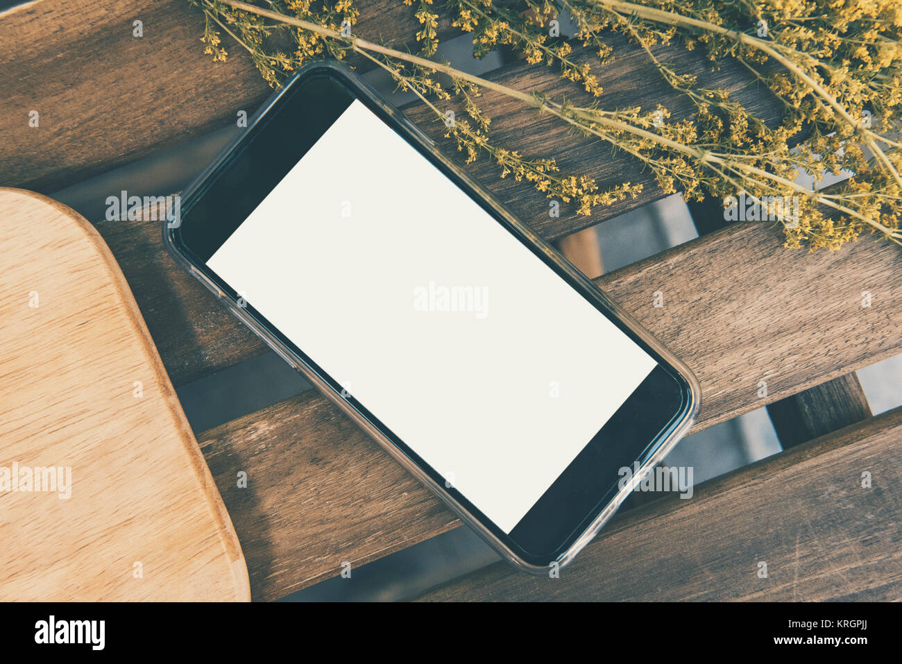 Phone on a wood table with copy space Stock Photo - Alamy
