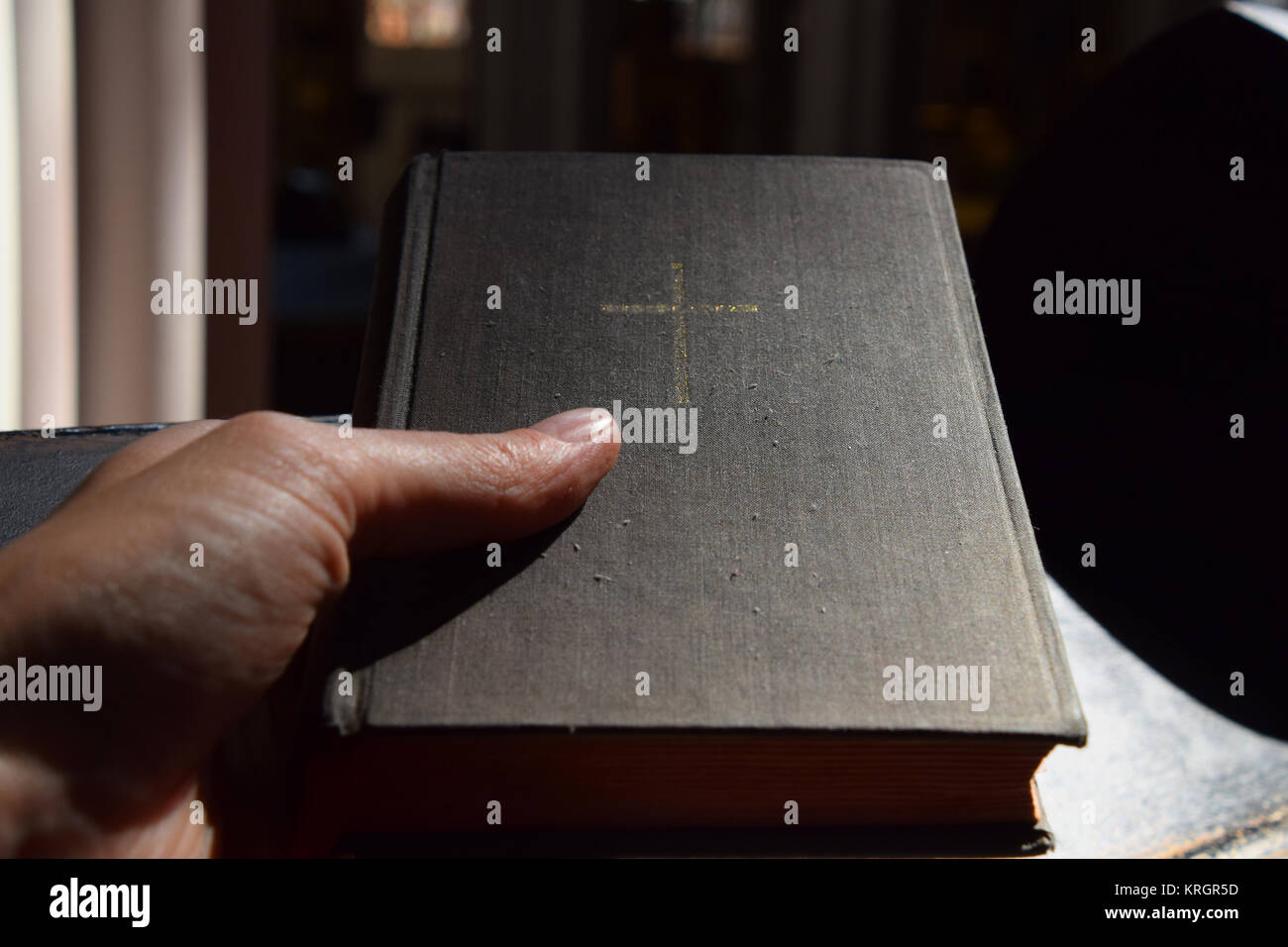 Man hand holding Bible in church over wooden pew Stock Photo - Alamy