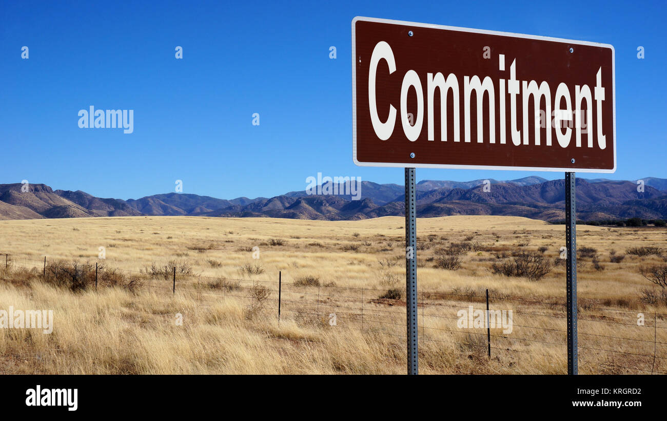 Commitment brown road sign Stock Photo - Alamy